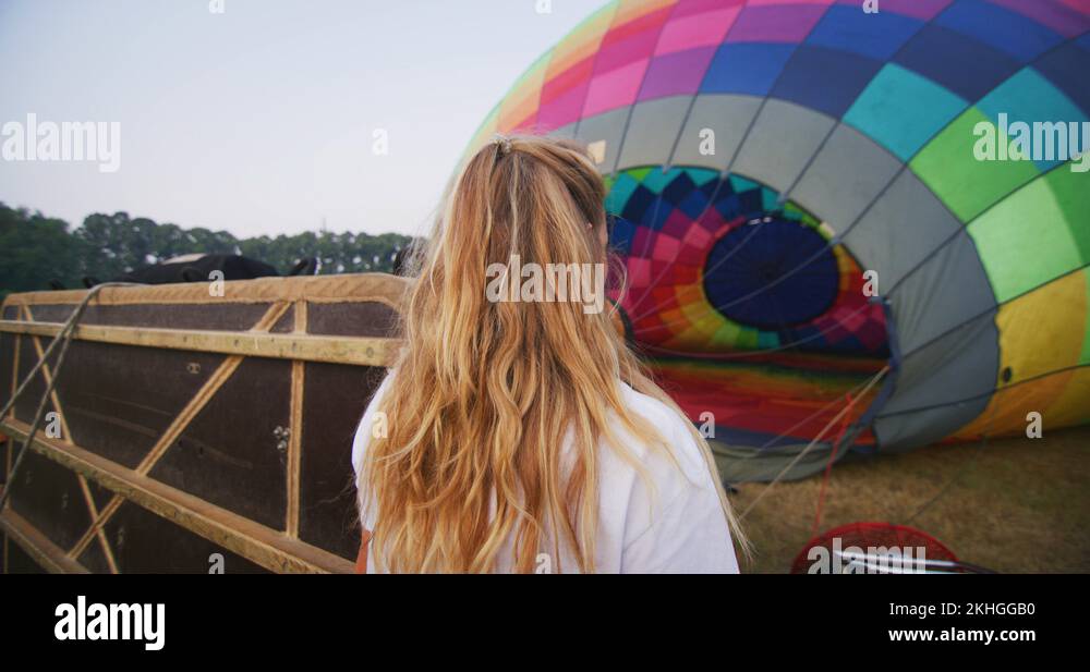 A female pilot is controlling hot air balloon is inflating before the ...
