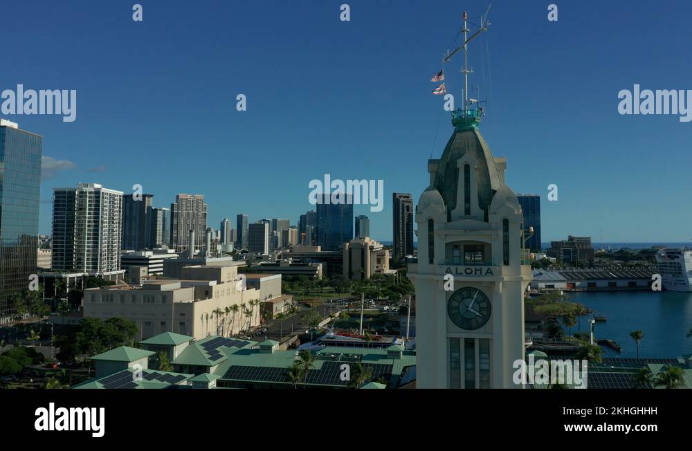 orbiting counter clockwise around iconic Aloha Tower revealing downtown Honolulu Stock Video ...