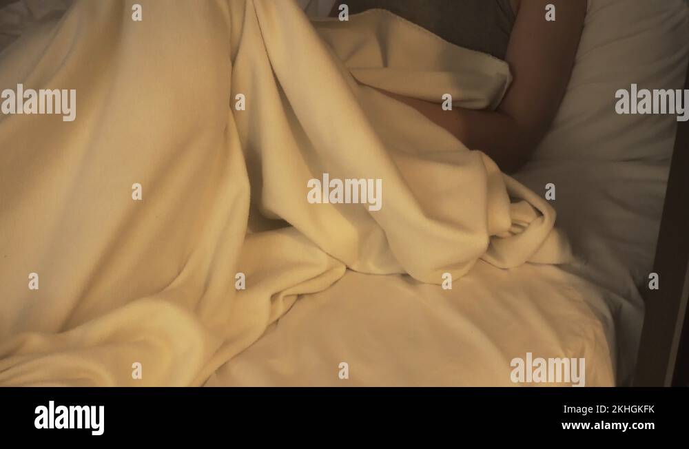 A young girl sits on a bed in a sleeping state Stock Video Footage - Alamy