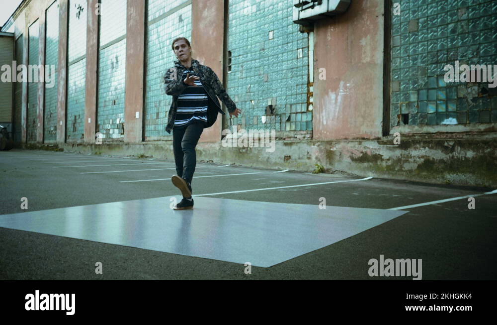 Hip-hop and breakdance. Breakdancer dancing in the street. Slow motion ...