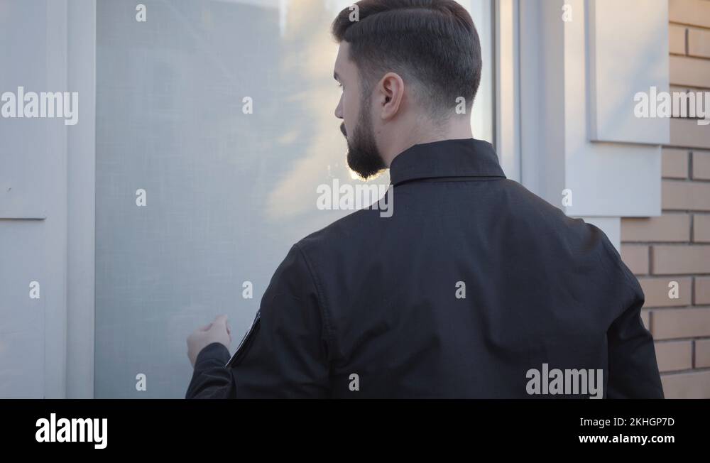 Male Caucasian police officer with brown eyes and black hair knocking ...