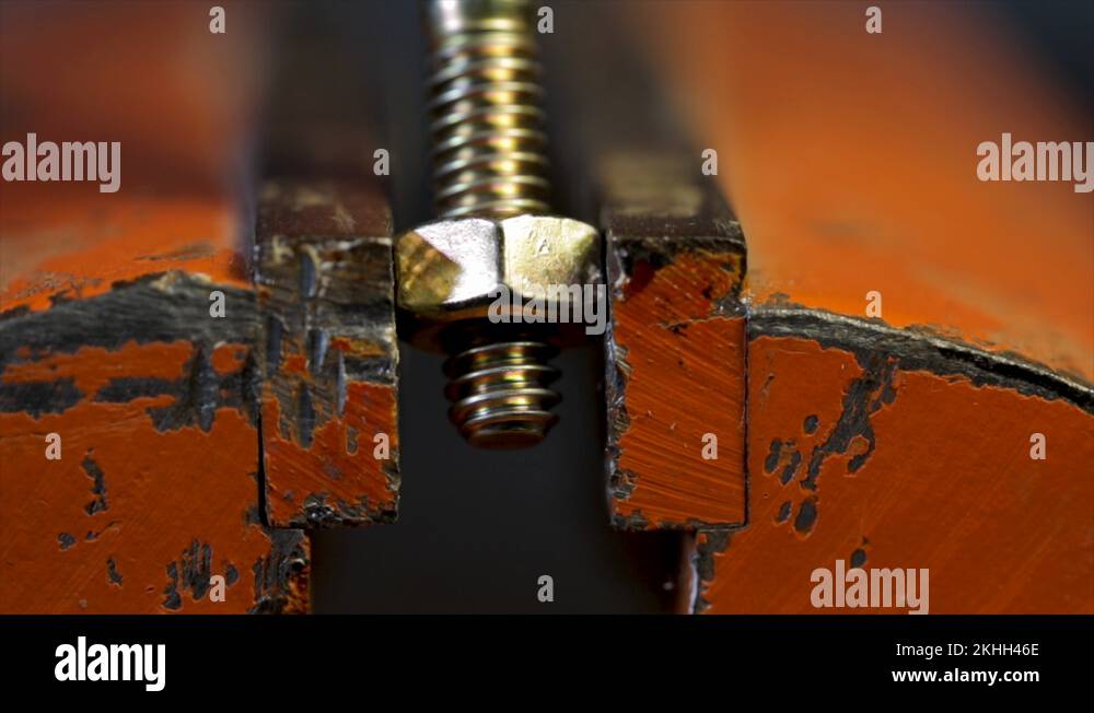 Nuts and Bolts in vice grip close up. Materials and tool in woodworking ...