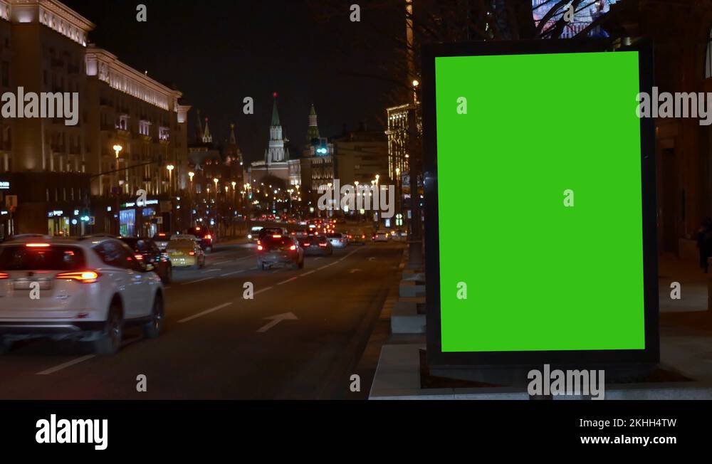 Showcase with a large green screen. Cars are coming. City street ...