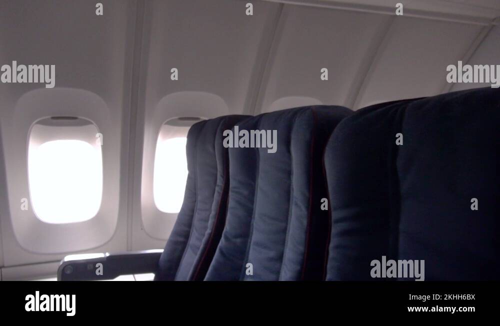 Pan view of empty passenger seat rows in Boeing 747. Passenger airplane ...