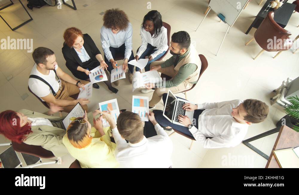 Fast and active teamwork of company employees, colorful graphs and ...