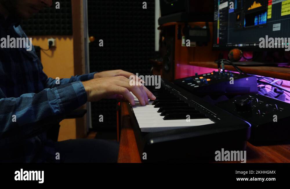 Man hands playing piano midi keyboard in home music studio. Male ...