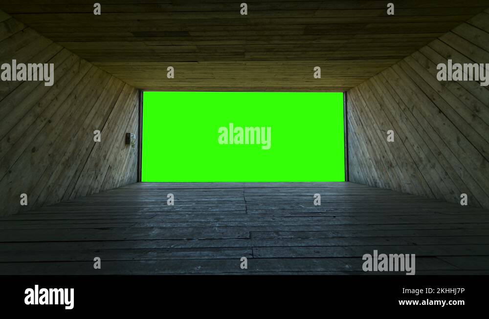 Empty wooden structure, building. Window with a green screen or chroma ...