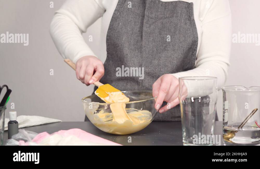 Mixing in food coloring into the royal icing to decorate sugar cookies ...