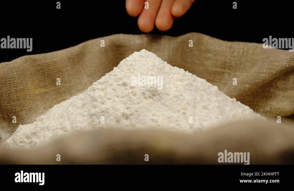 Male hand takes a pinch of a wheat powder from a top of pile Stock ...