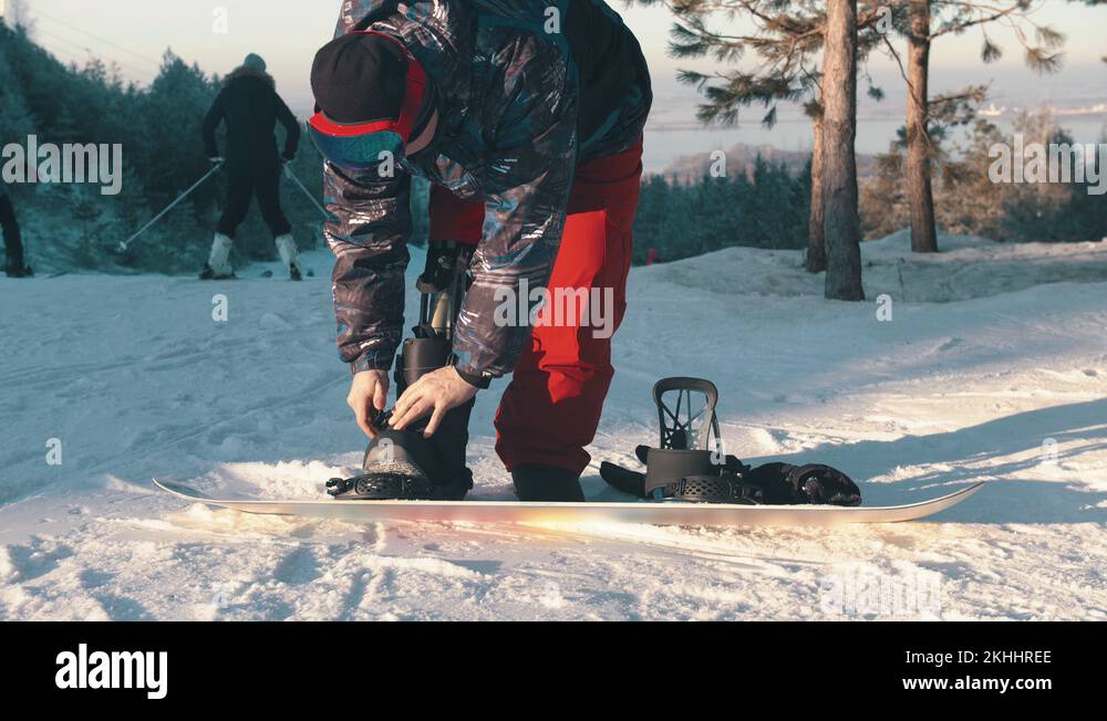 Snowboarding on the mountain - A man with prosthetic leg getting on the ...