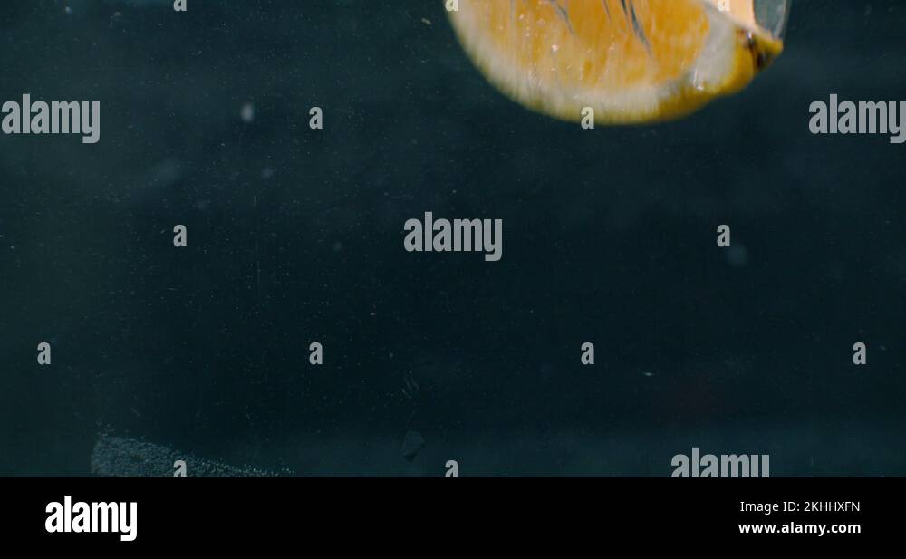 Several lemon fruits fall inside a water tank and disturb water. Three ...