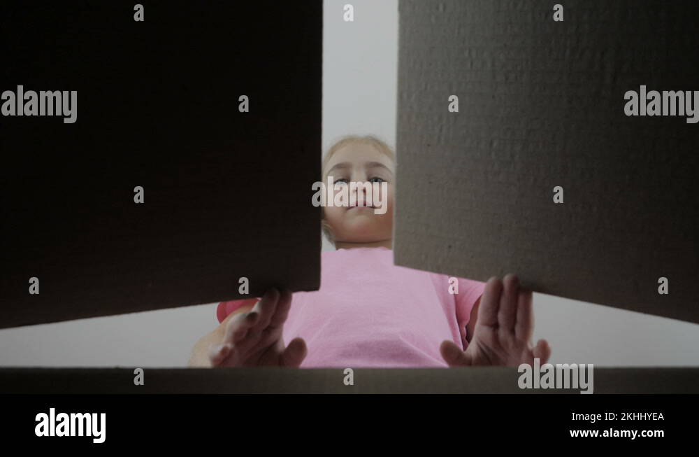 Little Girl Looks In Box, Surprised And Happy To Receive A Surprise ...