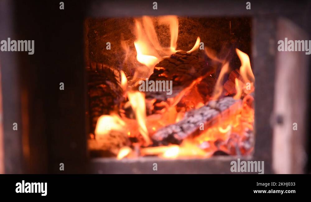 Fire in the classic russian bathhouse furnace. Tipical village life ...