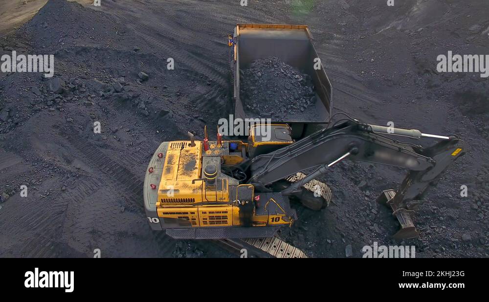 Fly over around, excavator loads coal into dump truck Stock Video ...