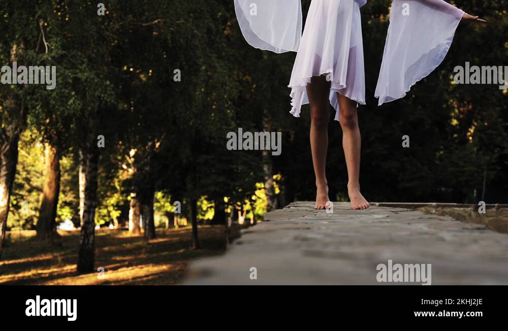 Bare feet little girl child go through concrete parapet theme homeless ...