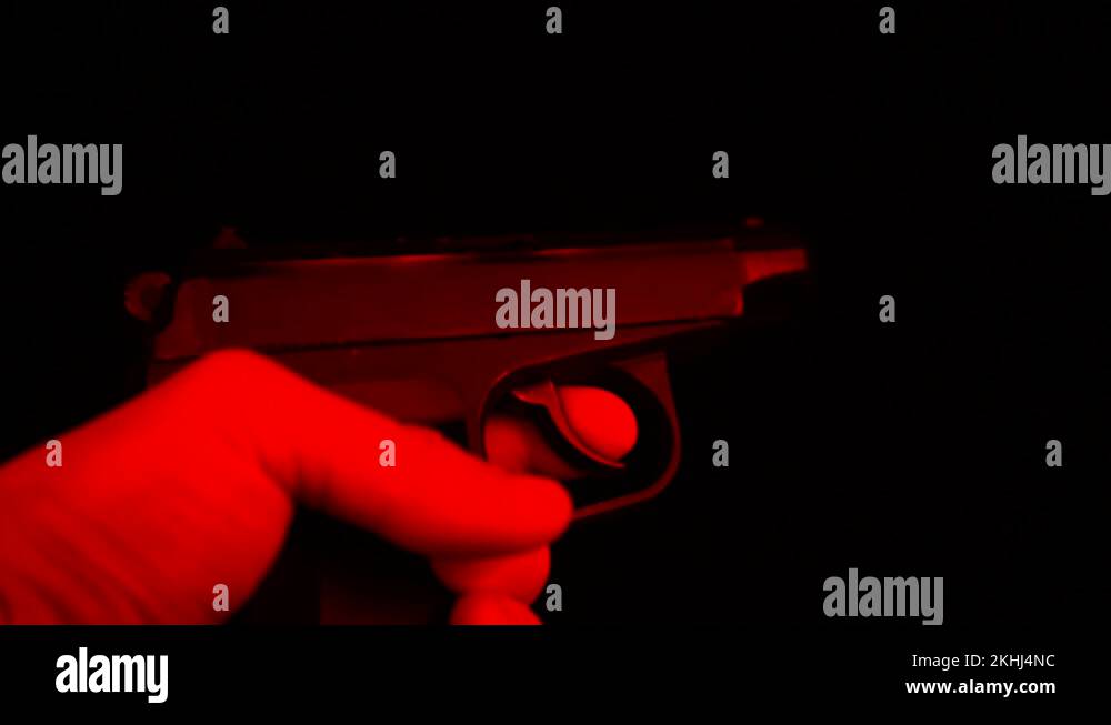 Male hand with a gun in a threatening gesture, a symbol of murder ...