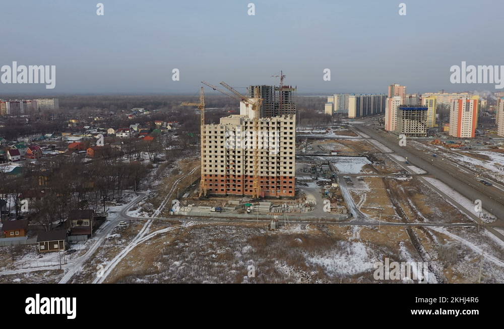 Construction of a large apartment building. Tower cranes and builders ...