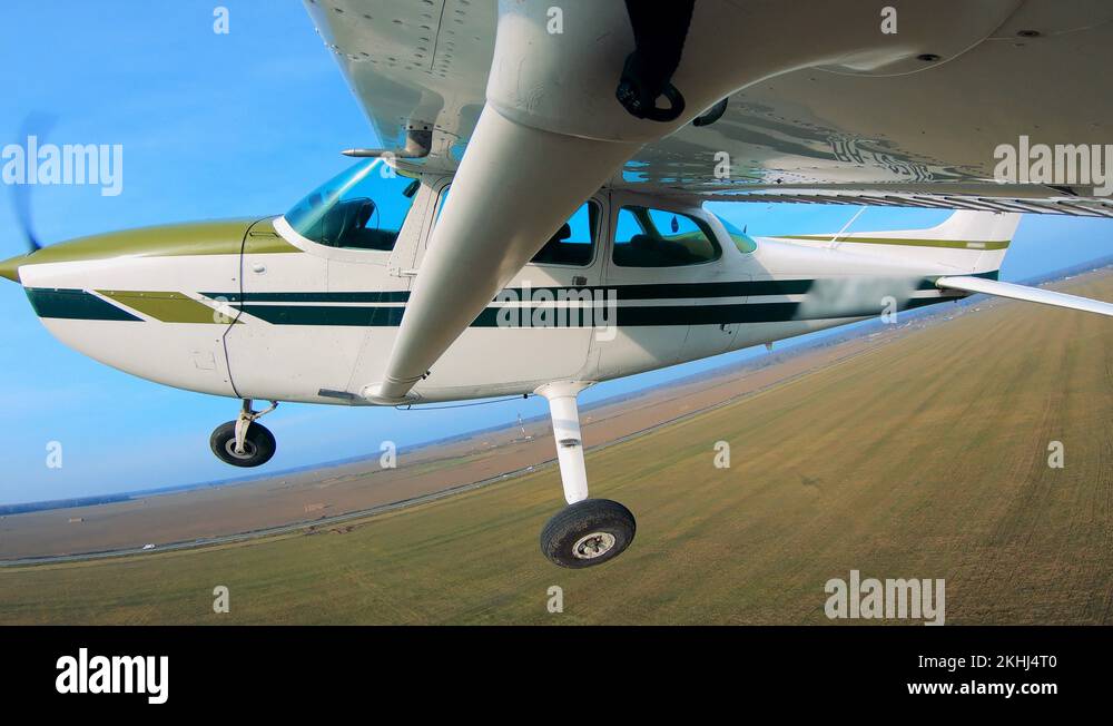Small aircraft is flying above the ground in a side view Stock Video ...