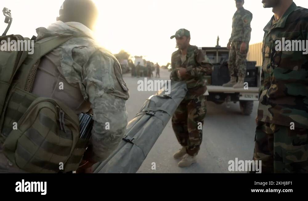 Afghan and U.S. soldiers loading supplies onto military vehicles Stock ...