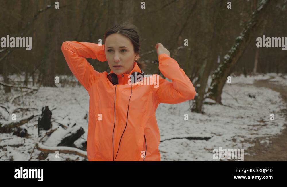 Female ties the tail. Woman tying the tail before run workouts in ...