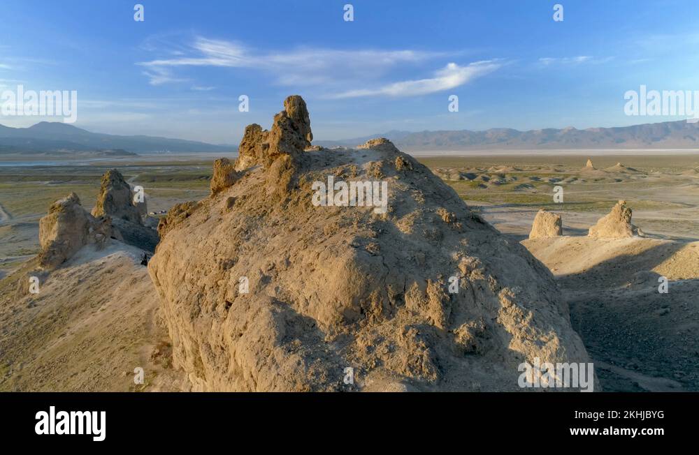 The collection of massive stone spires in the middle of the flat, dusty ...