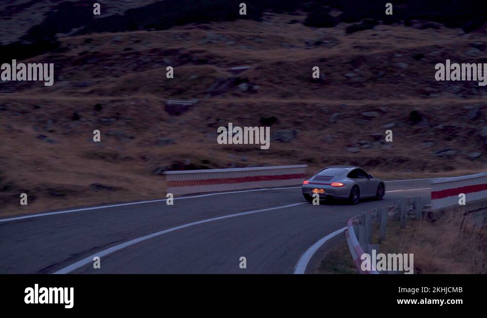 Crane Rolling Shot of a Porsche 911 Carrera car driving on ...