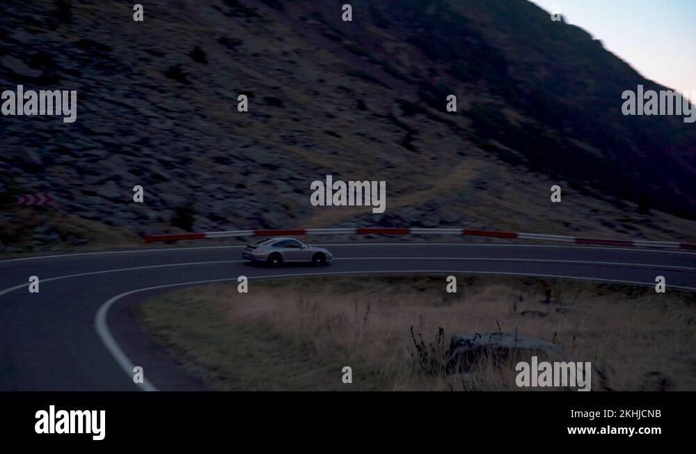 Crane Rolling Shot of a Porsche 911 Carrera car driving on ...
