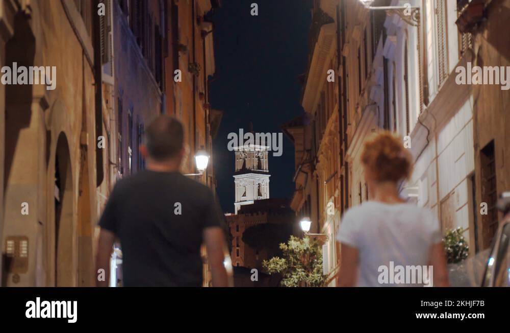 Night city life on ancient Roman street in the city centre. Illuminated ...