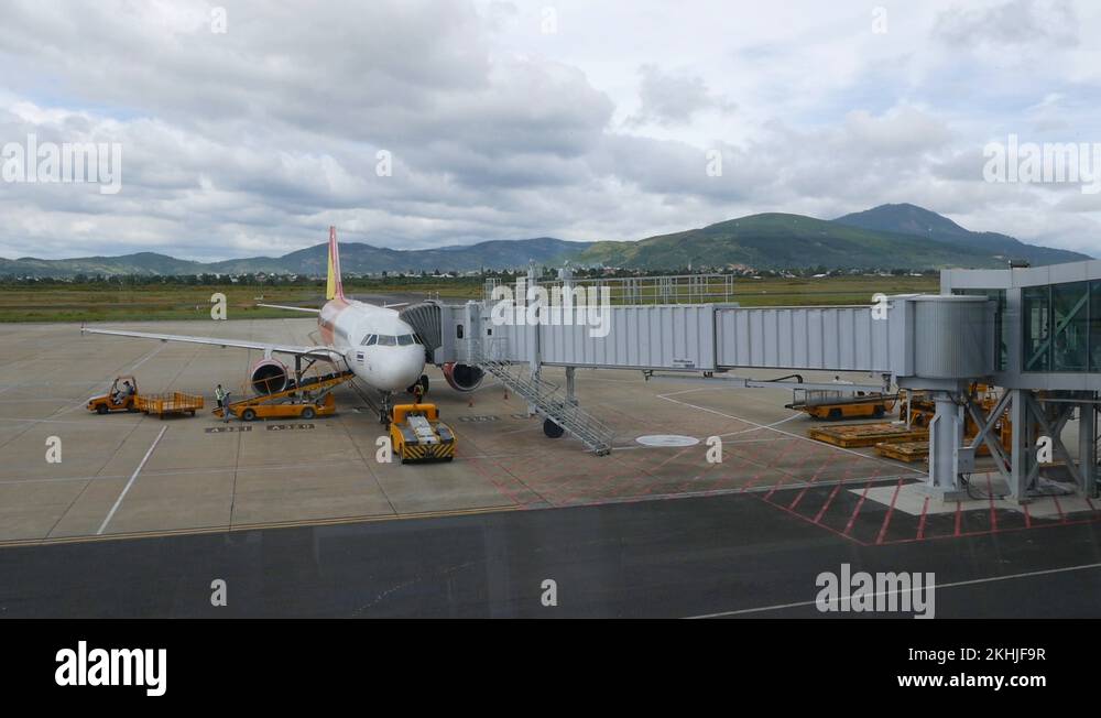 Airplane boarding and loading cargo containers. DALAT, VIETNAM ...