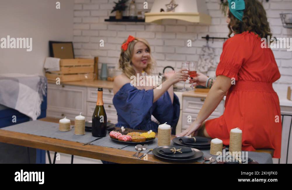 Portrait Of Cheerful Caucasian Women In Pin Up Style Who Drink Wine In
