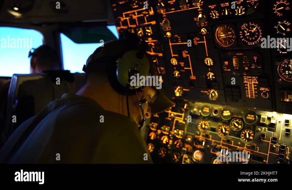 U.S. Air Force Flight engineer working at control panel aboard KC-10 ...