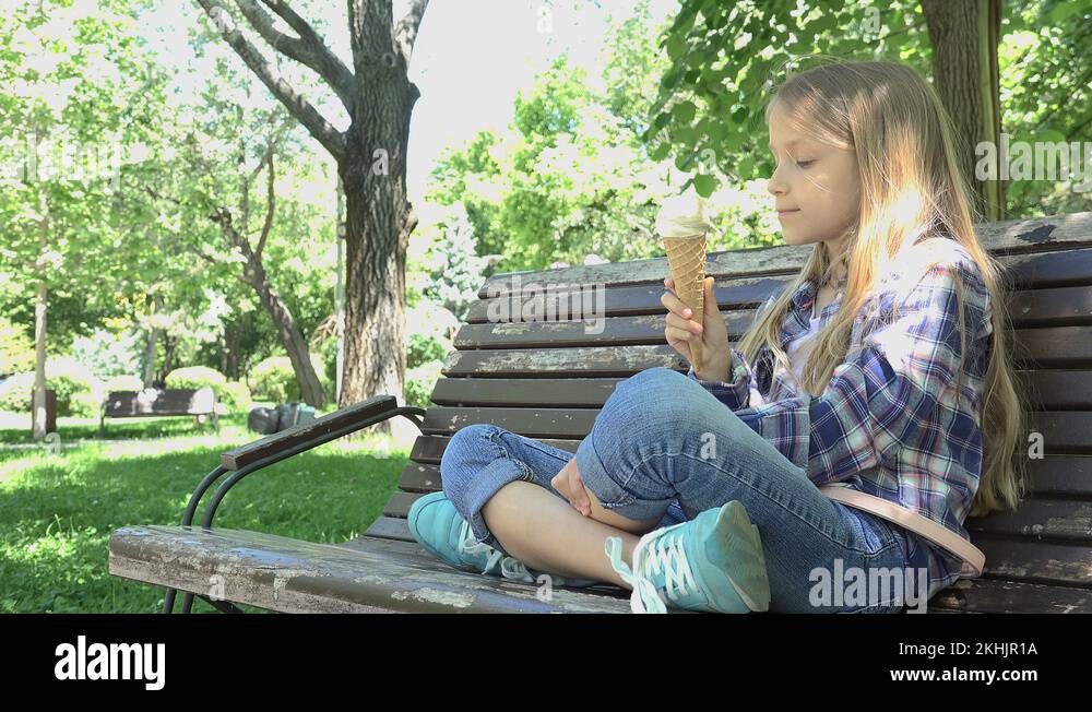 Kid Eating Ice Cream in Park, Child Relaxing Sitting on Bench Girl at ...