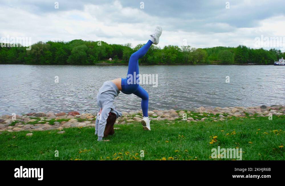 woman stretches standing in bridge position and raises leg Stock Video ...