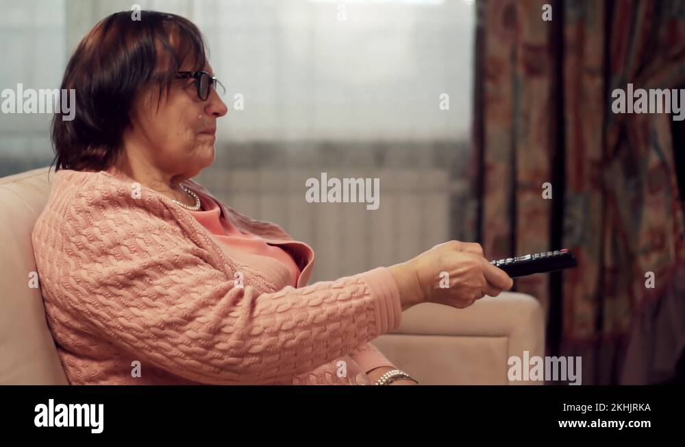 Zapping And Changing Channel.TV Remote.Senior Woman Using TV Remote ... Zapping And Changing Channel.TV Remote.Senior Woman Using TV Remote ...