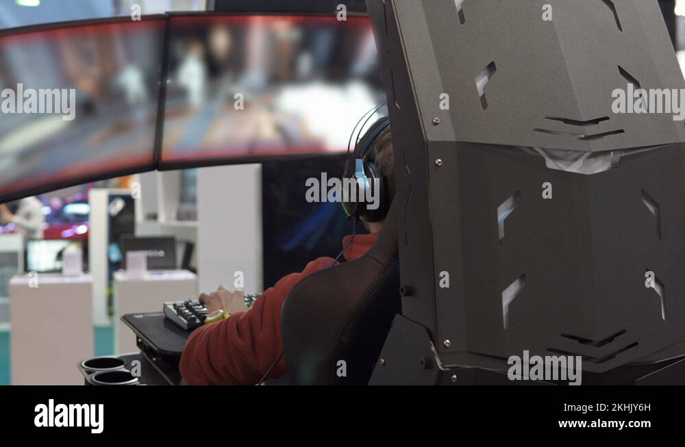 The guy sits in a gaming chair with three monitors Stock Video Footage ...