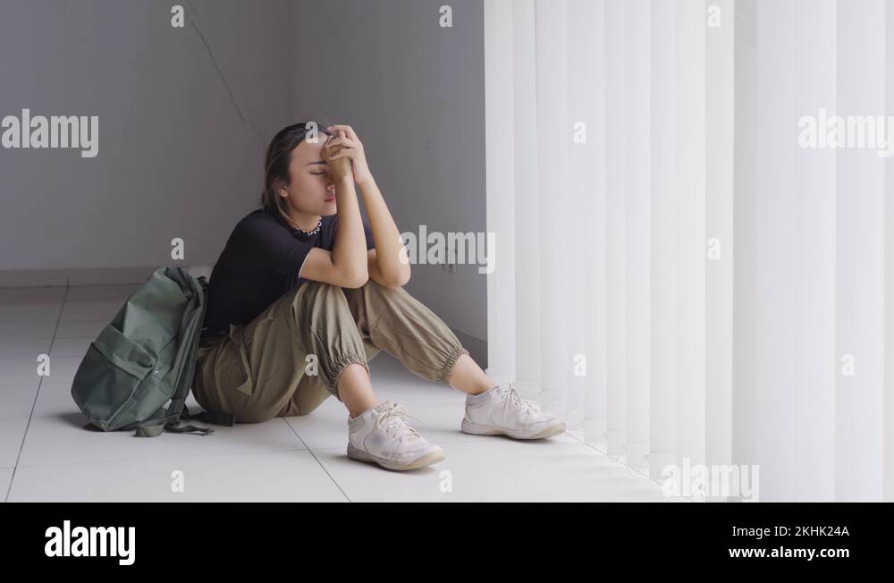 Female high school student crying near the window Stock Video Footage ...
