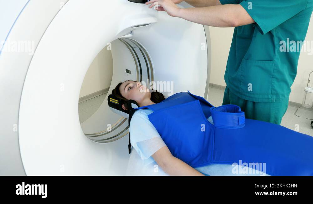 Female patient is on medical examination on MRI or computed tomography ...