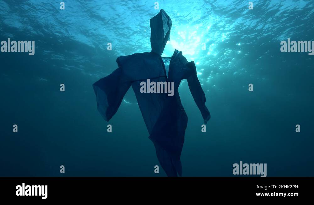 Blue plastic raincoat as a ghost slowly float in the blue water ...