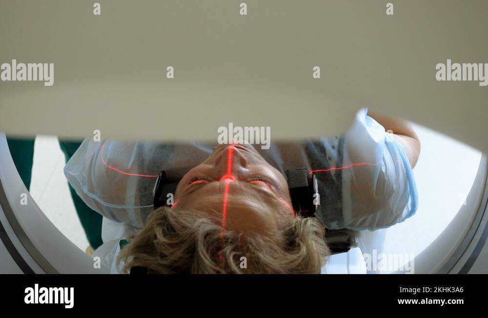 Female patient is undergoing MRI or CT scan under control of a ...