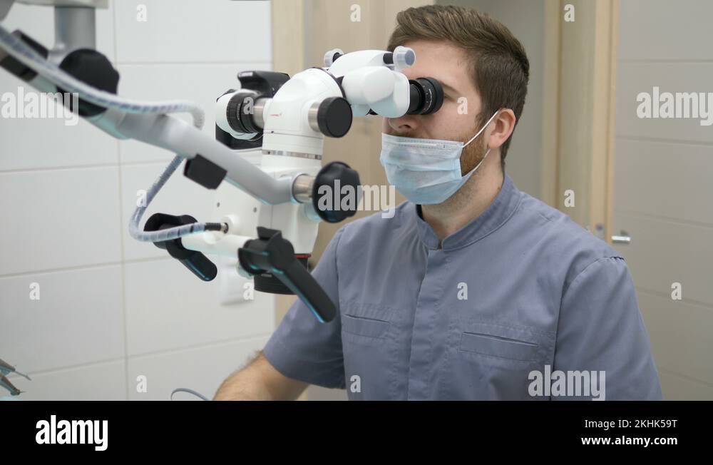 A dentist uses a modern electron microscope to treat dental caries in a ...