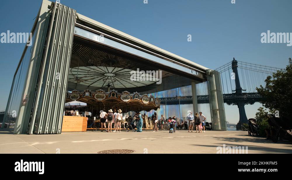People walk along the riverside path by Jane’s carousel and the ...