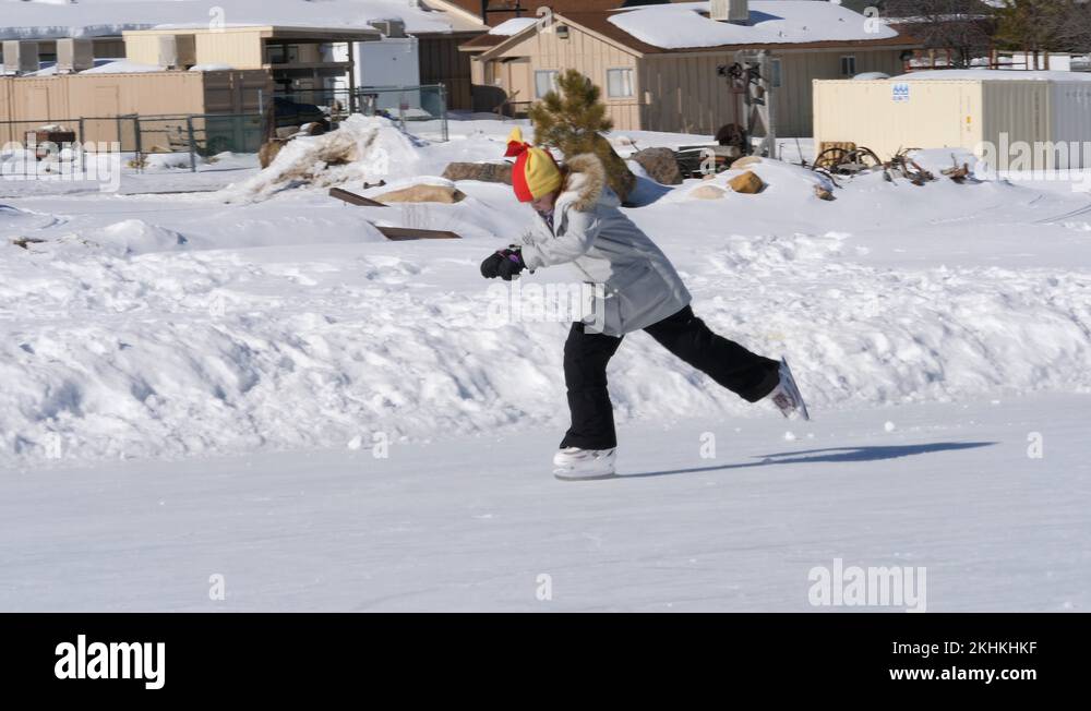 A cute girl ice skating on an outdoor ice skating rink Stock Video ...