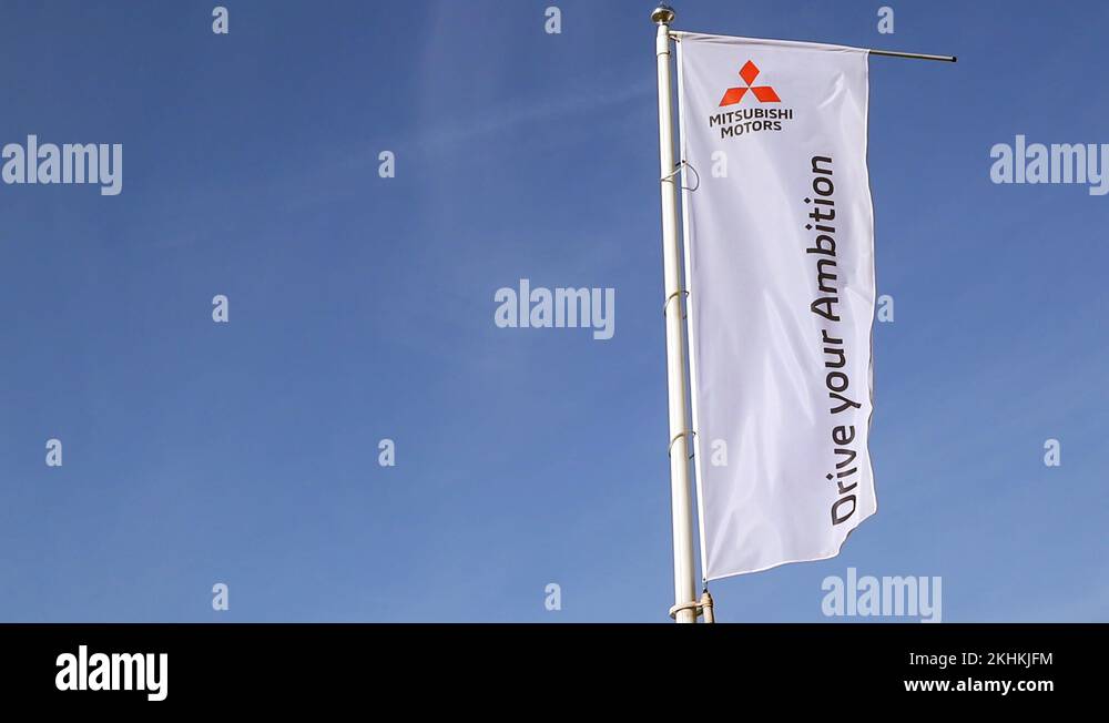 white Flag with Mitsubishi motors logo and words drive your ambition ...