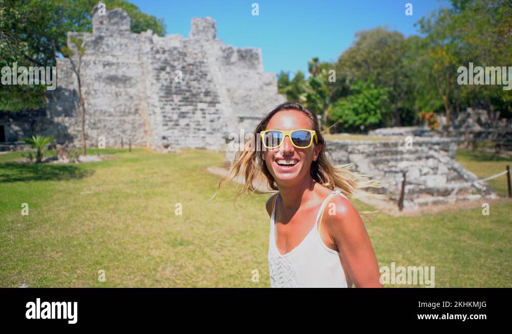 Come with me, woman leading the way walking towards ancient temple in ...