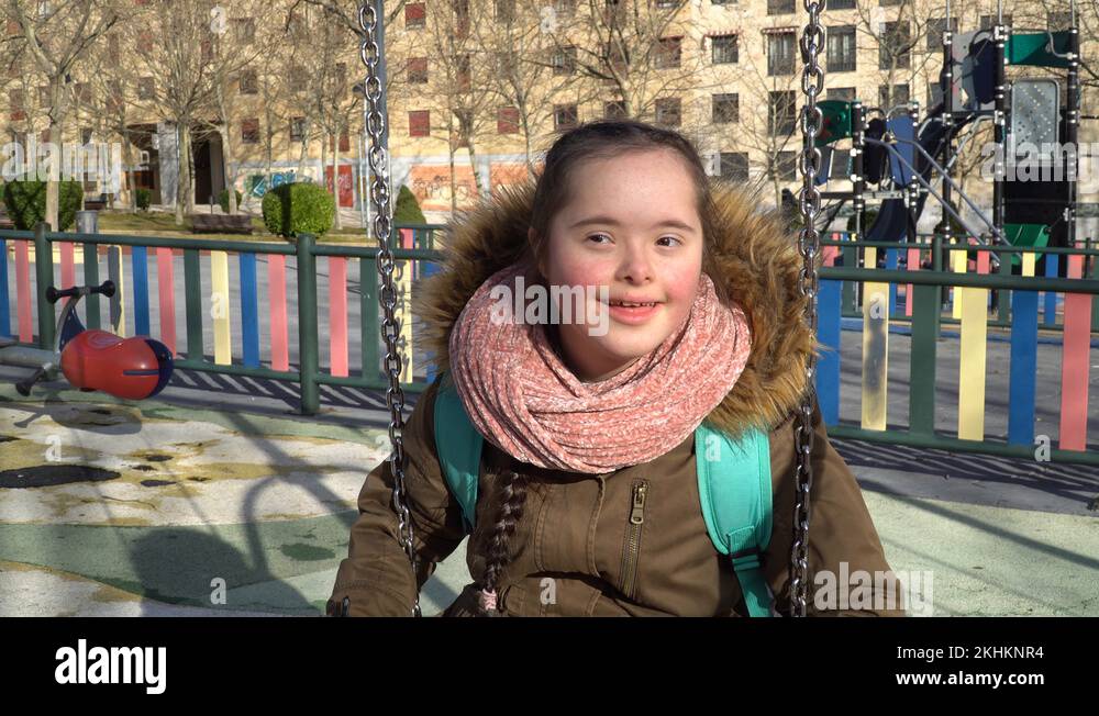 Little girl with down syndrome having fun on the swing Stock Video ...