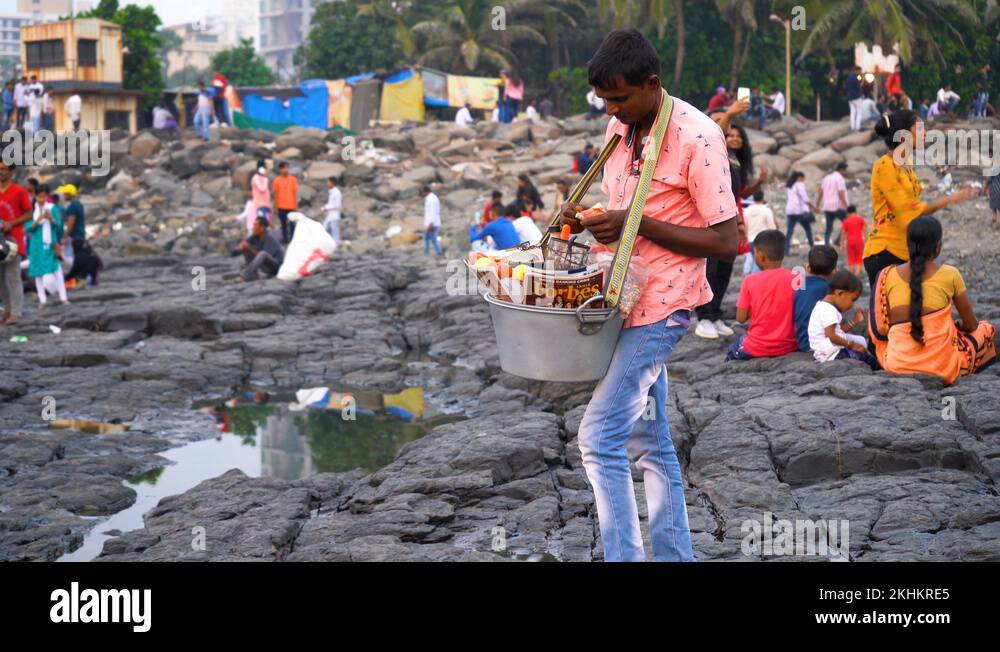 Poor indian street hawker selling bhel puri among the crowds of ...