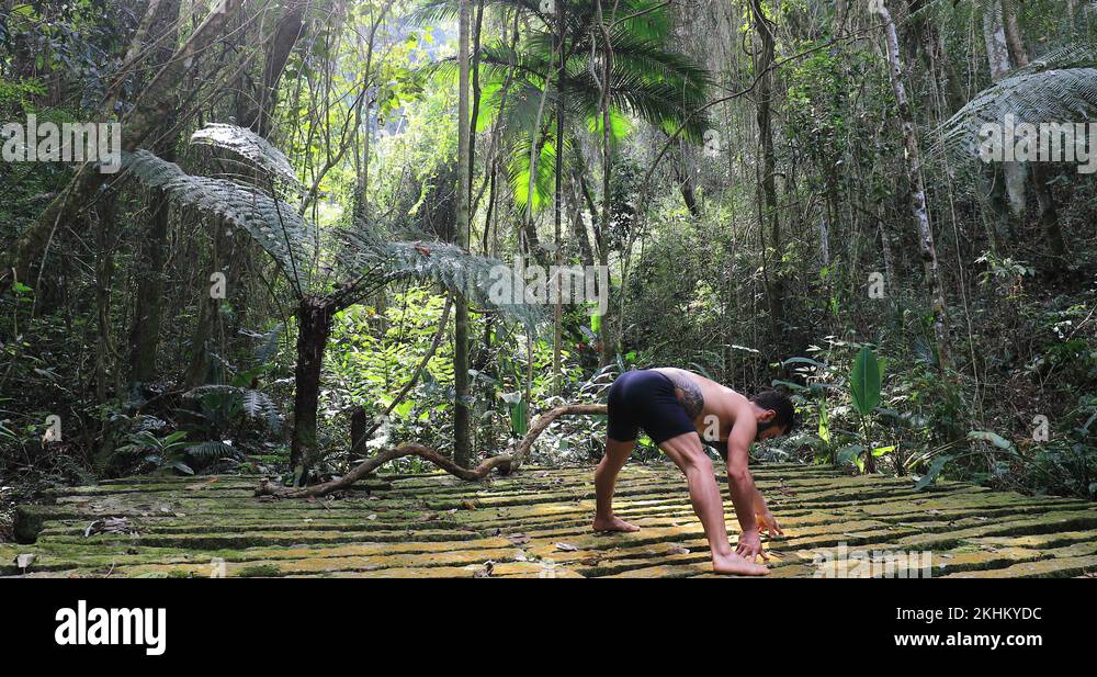 Man stretching legs in the middle of tropical jungle Stock Video ...