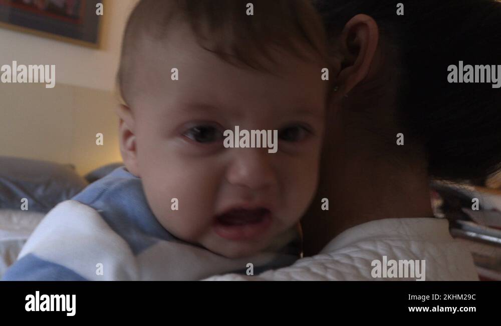 Mother hugging upset angry baby Stock Video Footage - Alamy