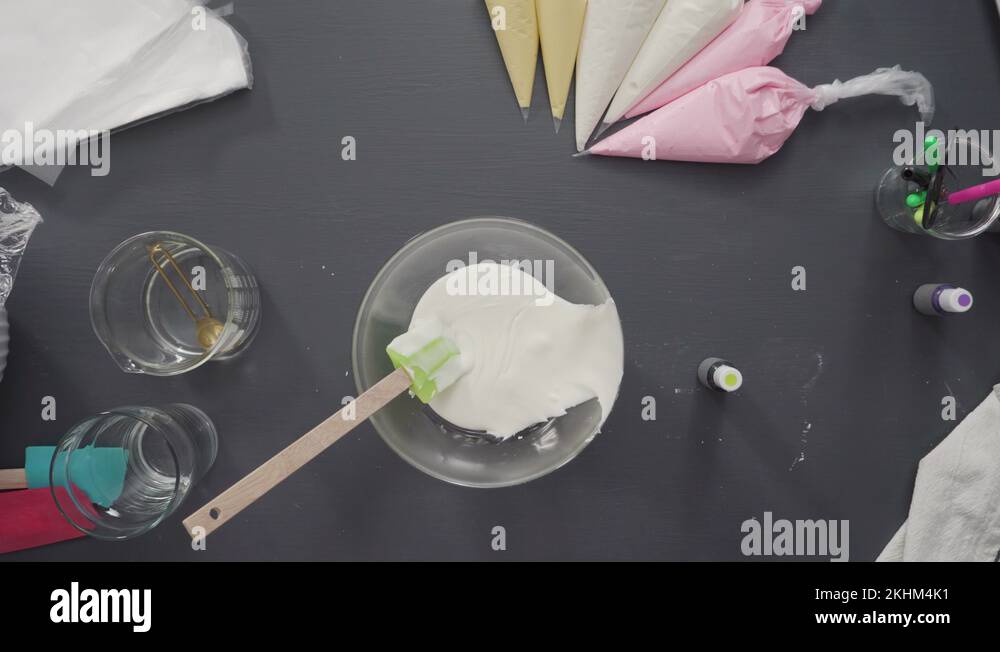 Mixing in food coloring into the royal icing to decorate sugar cookies ...