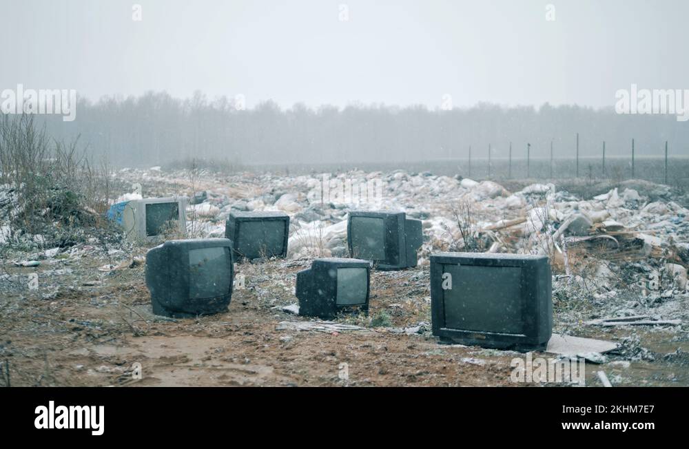 Snowfall at the rubbish dump woth broken TVs Stock Video Footage - Alamy